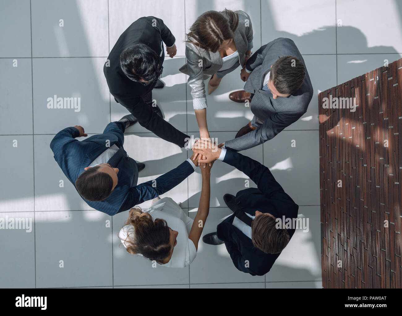 top view. a group of business people with their hands folded together ...