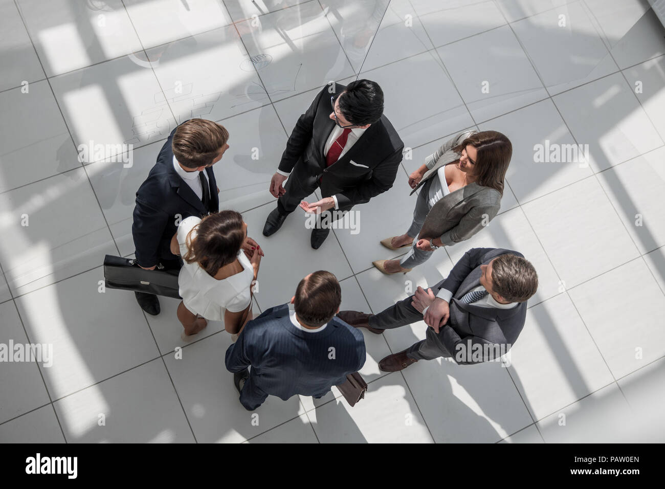 top view. employees standing in a modern office Stock Photo - Alamy