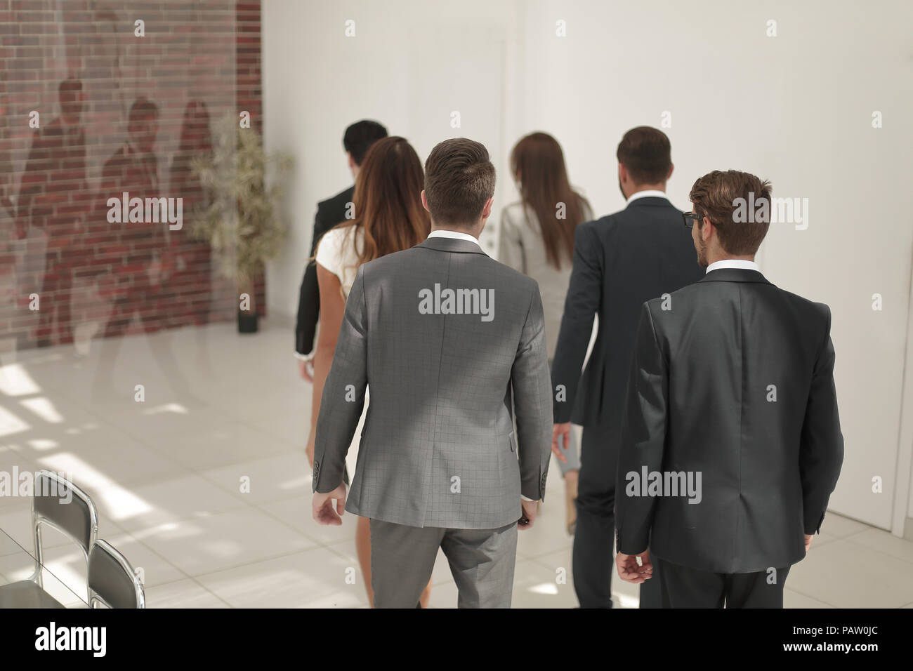 rear view.employees standing in a modern office Stock Photo - Alamy