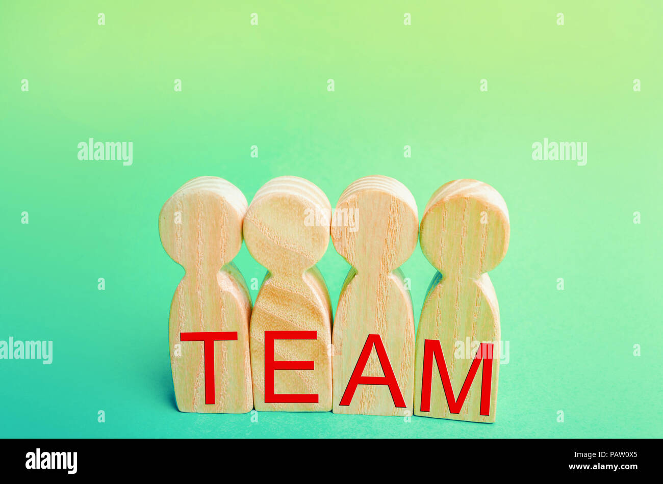 four wooden people with the inscription "team". group work. teamwork ...