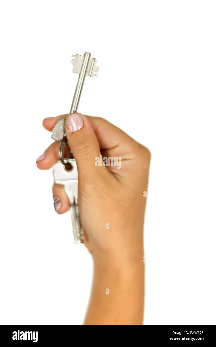female hand holding keys on white background Stock Photo - Alamy