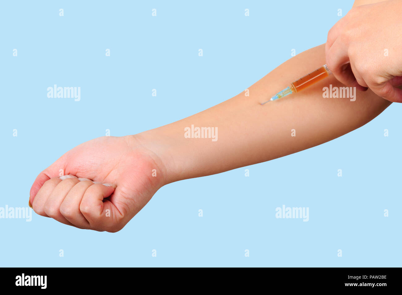 Close-up of hand, giving vaccination to patient using a syringe with ...