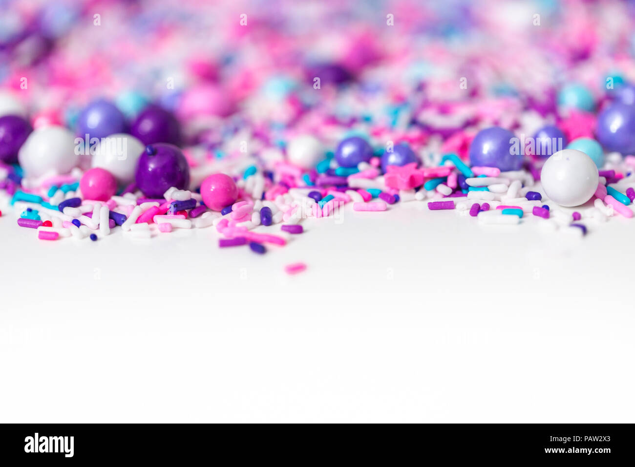 Colorful purple sprinkle blend on a white background Stock Photo - Alamy