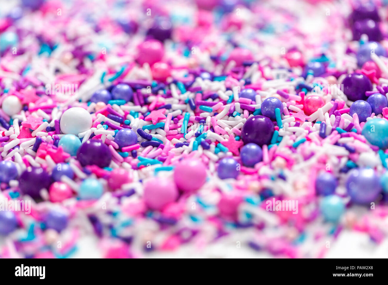 Colorful purple sprinkle blend on a white background Stock Photo - Alamy