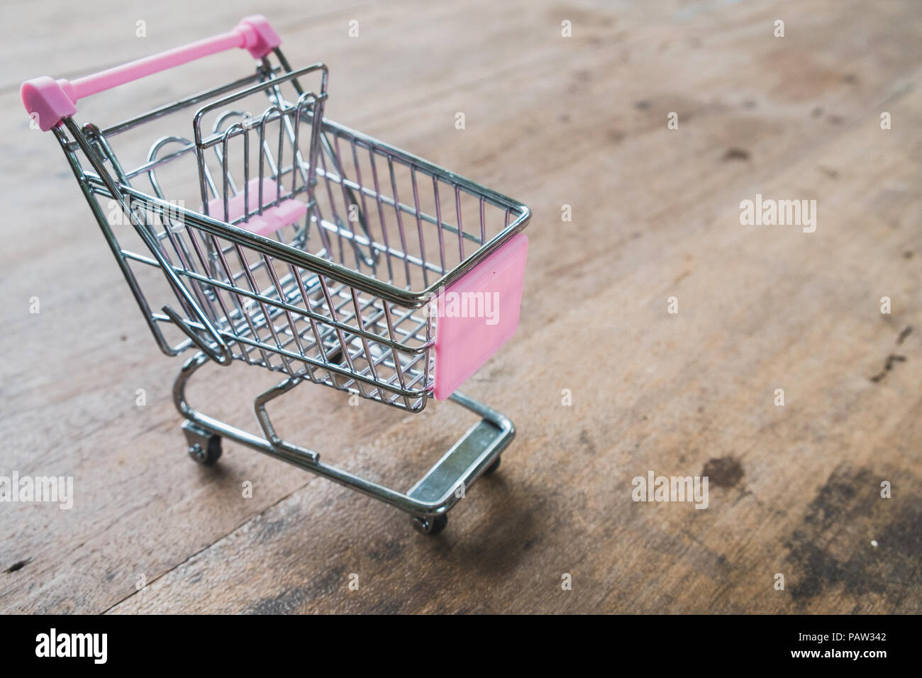 Small shopping cart,Empty shopping trolley on wooden floor Stock Photo ...