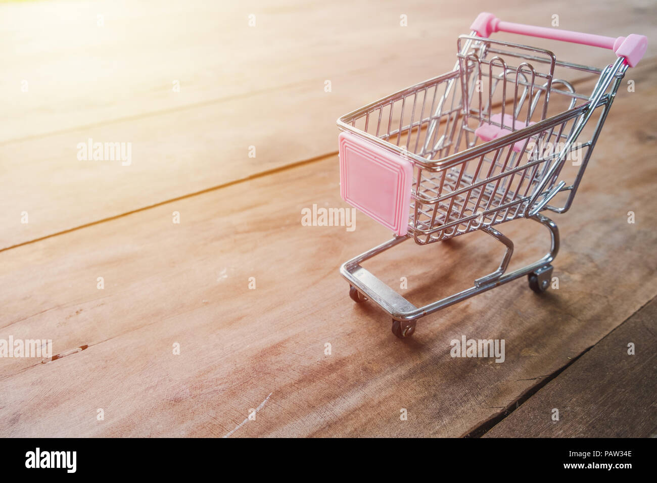 Small shopping cart,Empty shopping trolley on wooden floor Stock Photo ...