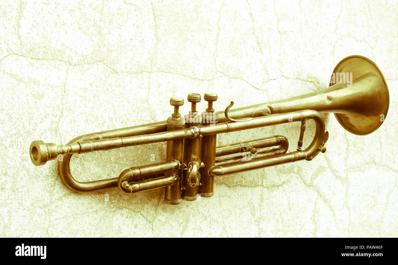 a trumpet hanging on the wall Stock Photo - Alamy