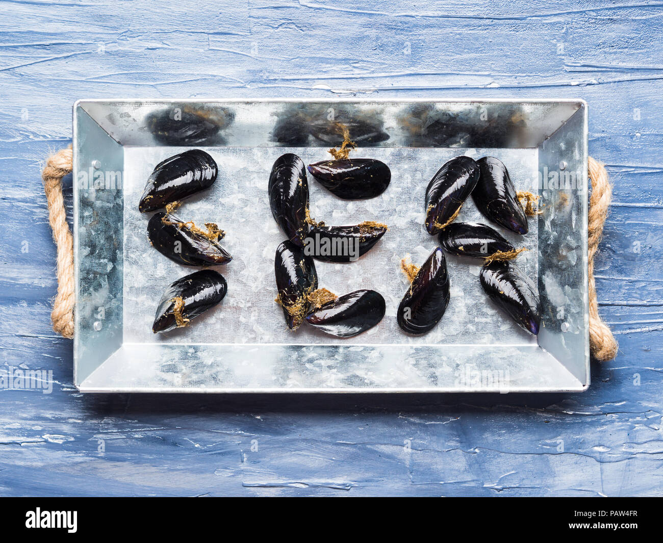 Word Sea written with raw mussels on a silver tray Stock Photo - Alamy