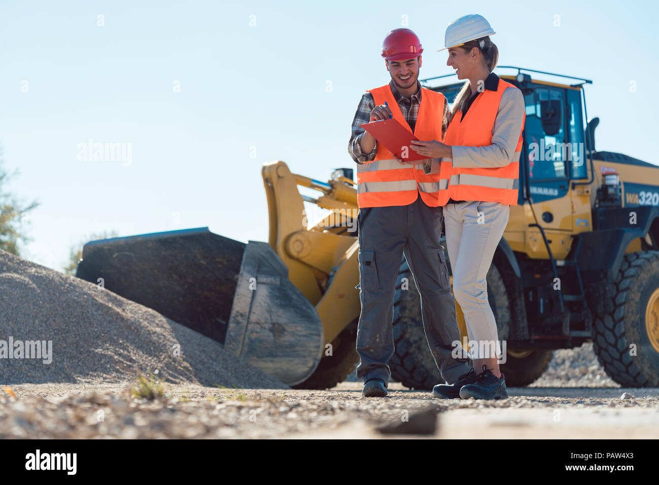 Man and woman worker on construction site Stock Photo - Alamy