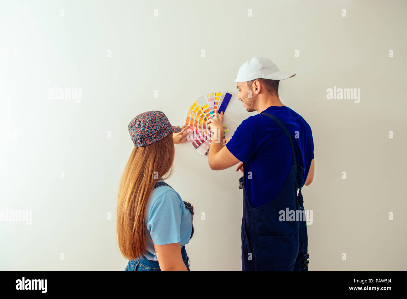 Photo from back side of two person while choosing color from color ...