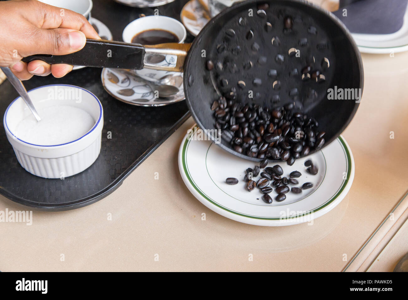 Pouring freshly roasted coffee beans at an authentic Ethiopian Coffee ...
