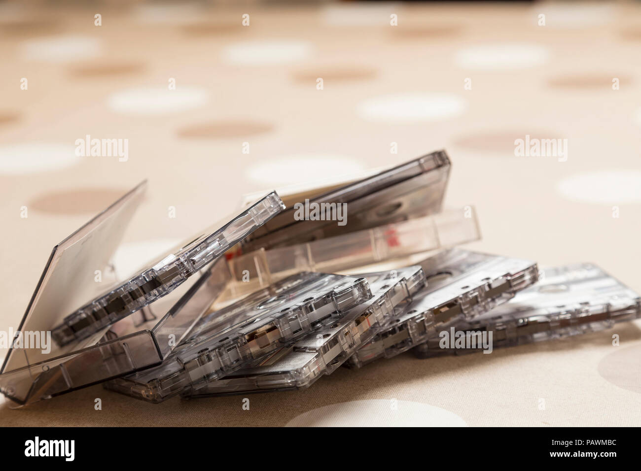 view of several old cassette tapes, some with their boxes, in a heap ...