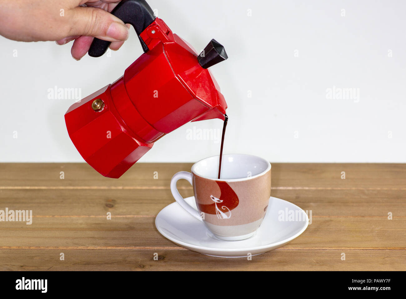 Pouring a hot expresso coffee into a glass Stock Photo - Alamy