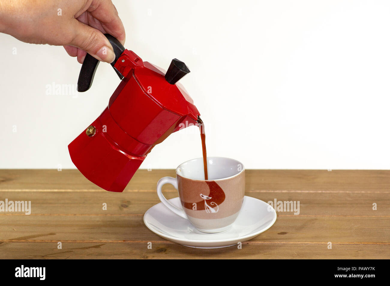 Pouring a hot expresso coffee into a glass Stock Photo - Alamy
