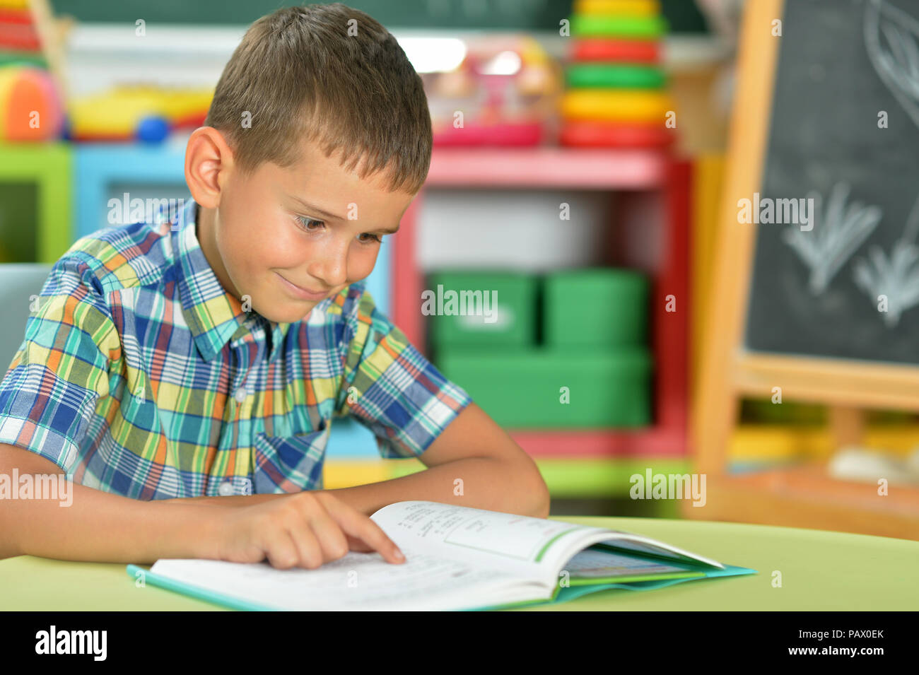 Portrait of boy reading book Stock Photo - Alamy