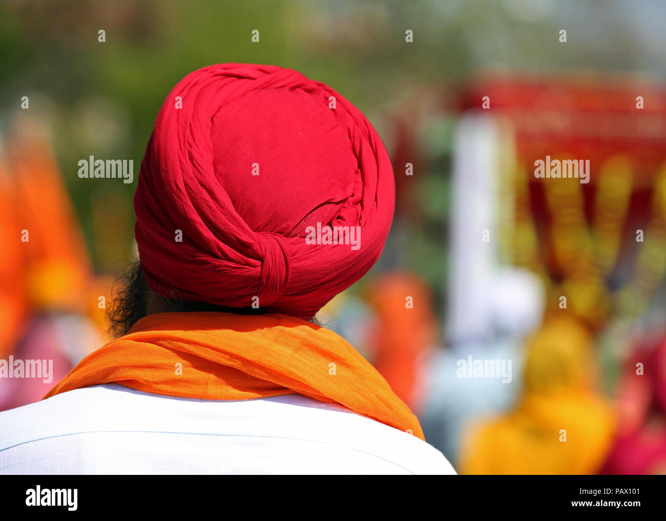old sikh man with red turban on his head during a religious ceremony ...