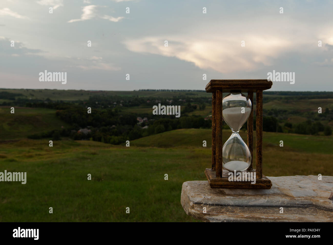 hourglass as a symbol of the passing time stand on a white stone marble ...
