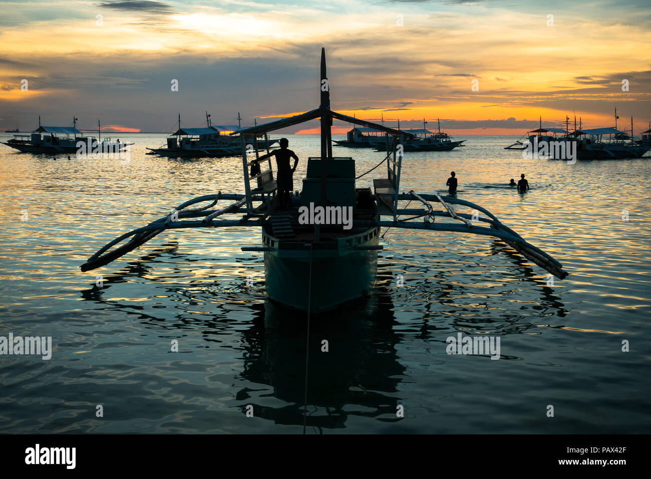 Tour Guide and Crew Sunset Silhouette as They Dock Their Boat For the ...