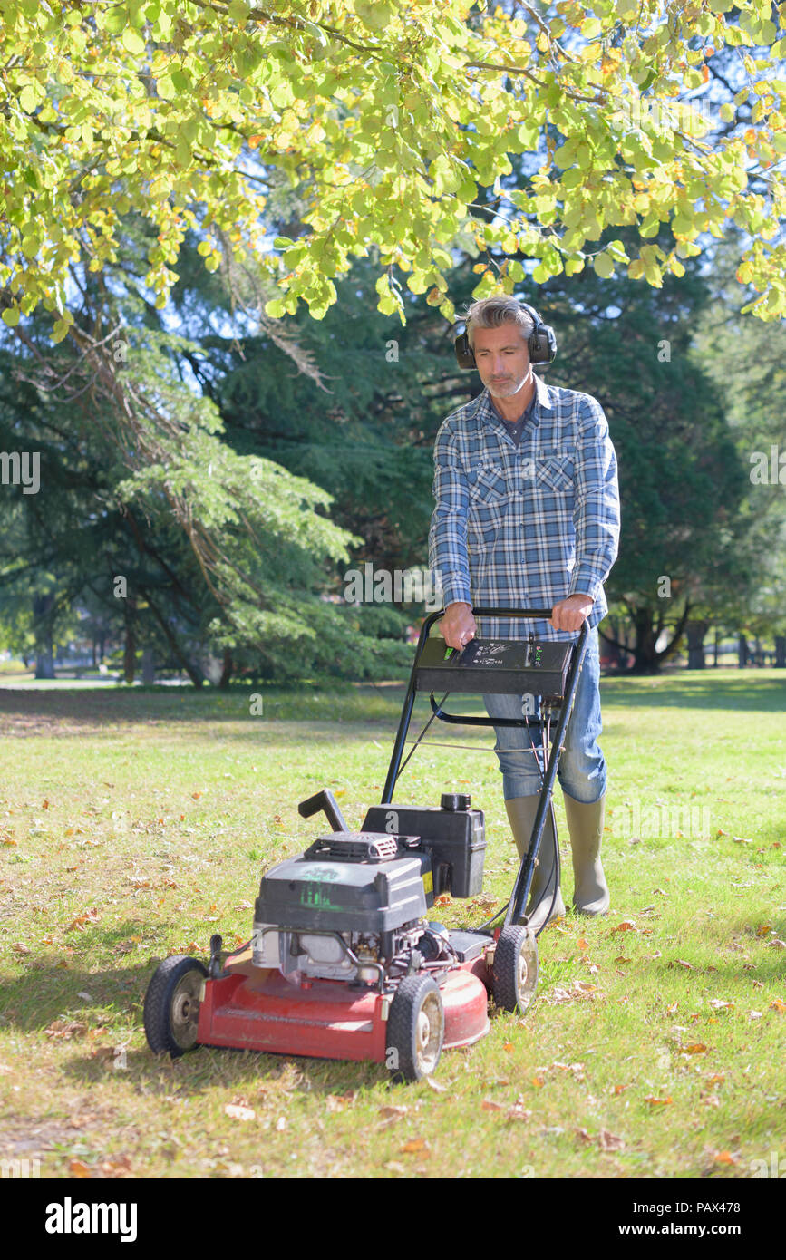 man with lawn mower Stock Photo - Alamy