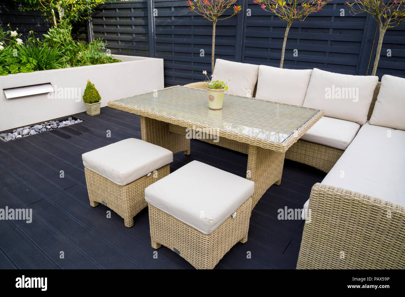 Seating area on black composite decking Stock Photo - Alamy