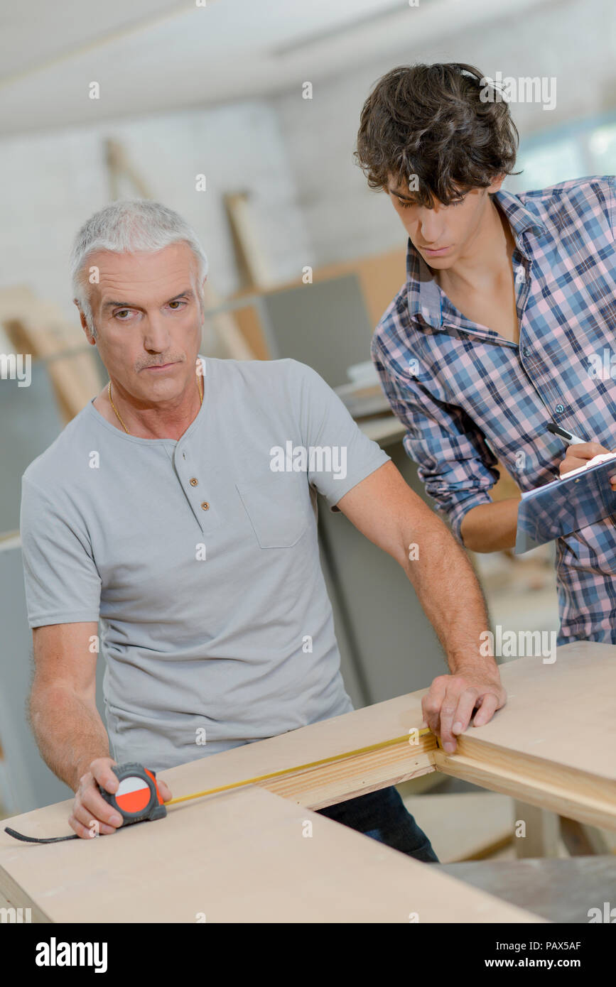 Carpenters measuring up wood Stock Photo - Alamy