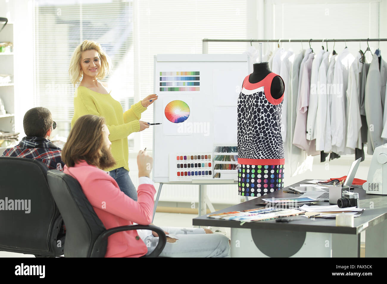 woman pointing at swatch color palette while discussing what color to ...