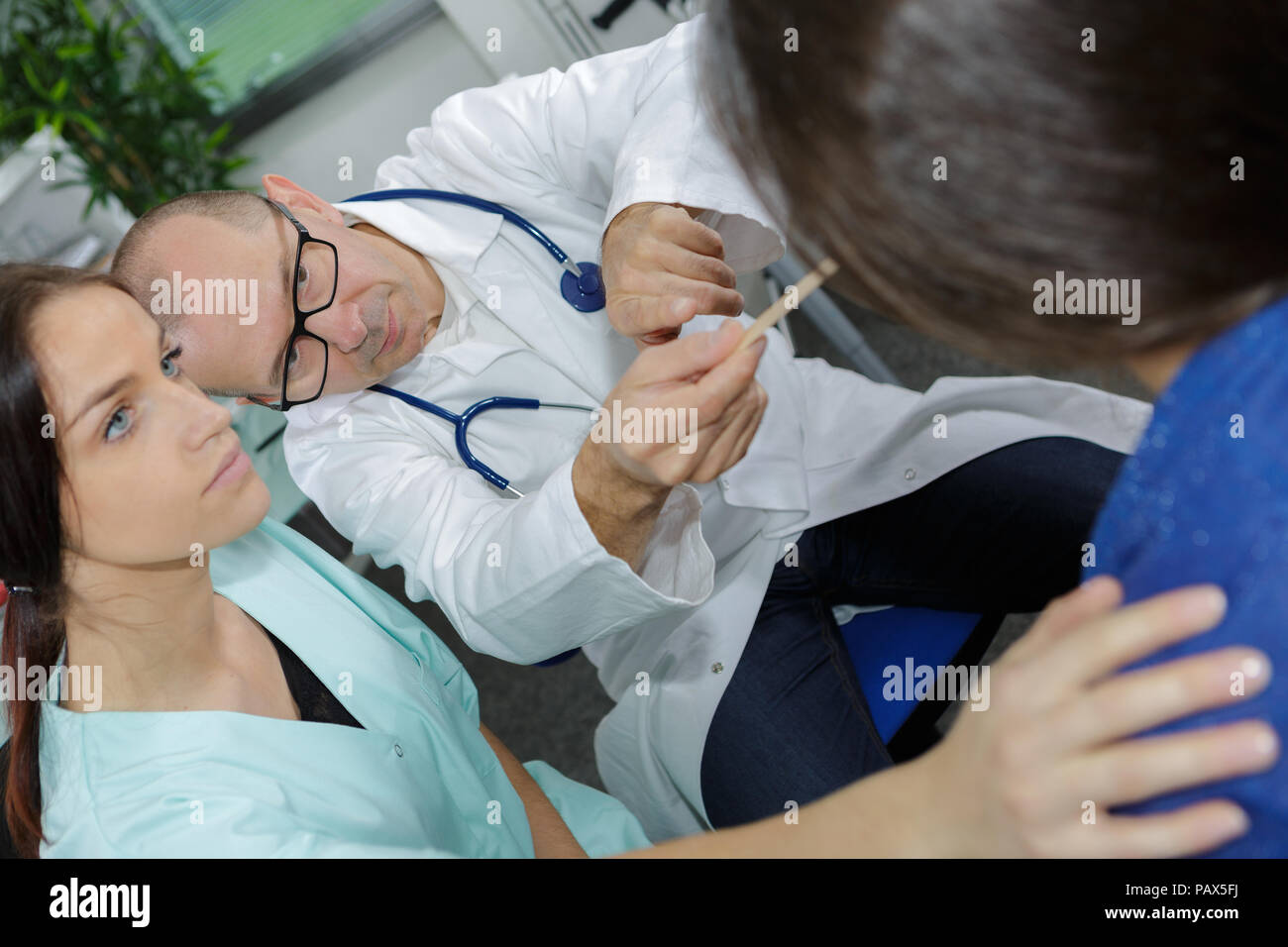 female doctor and student working together Stock Photo - Alamy
