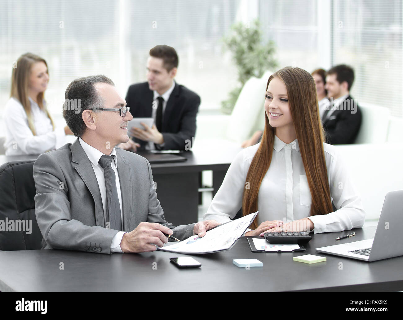 Marketer and team Manager working with paper charts Stock Photo - Alamy