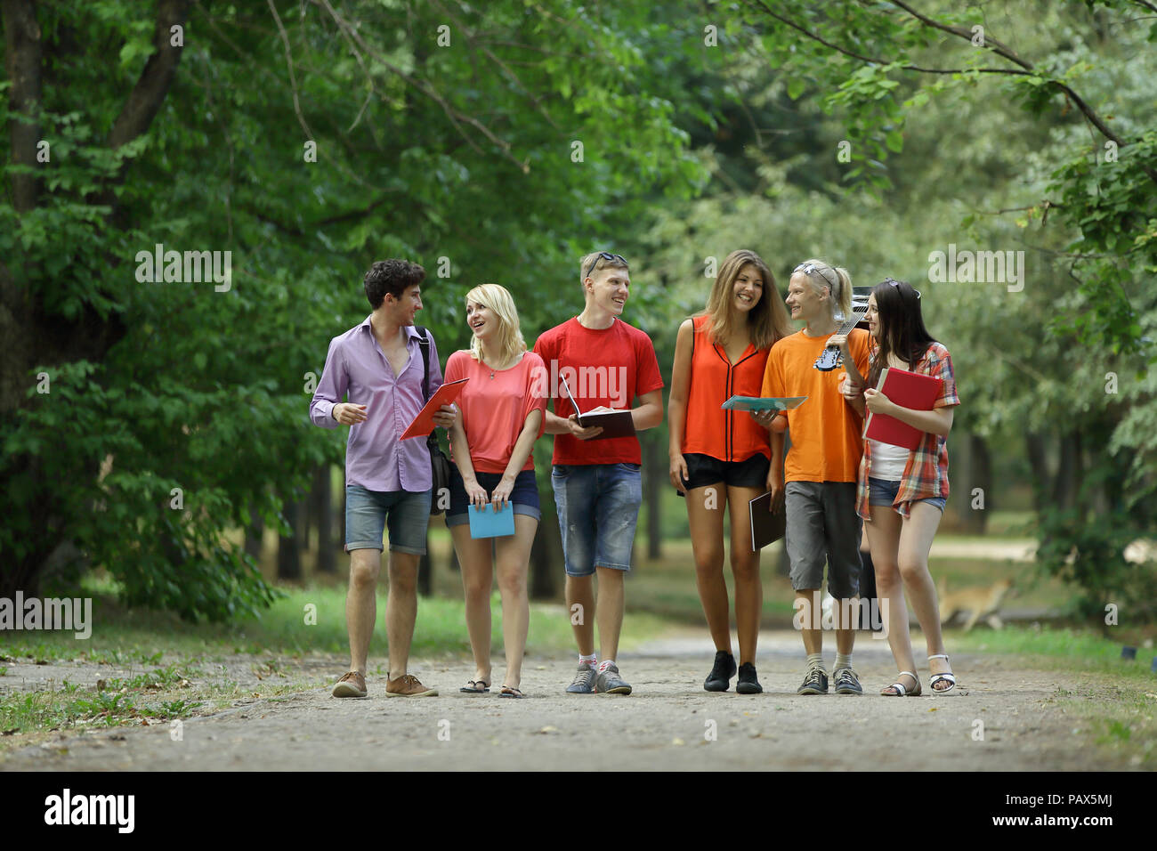 group of young students walking together in a high school university ...