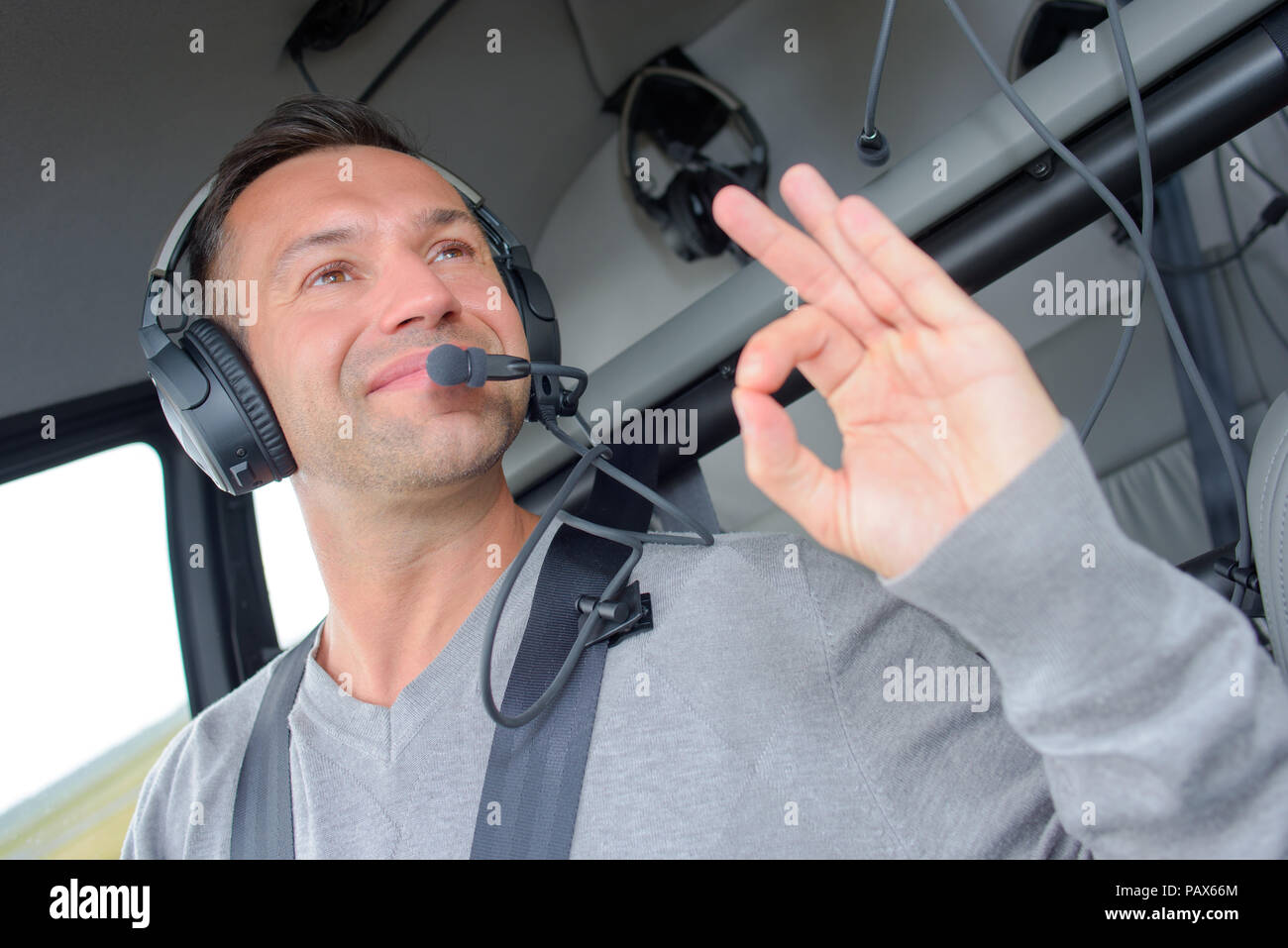 Pilot making positive hand gesture Stock Photo - Alamy