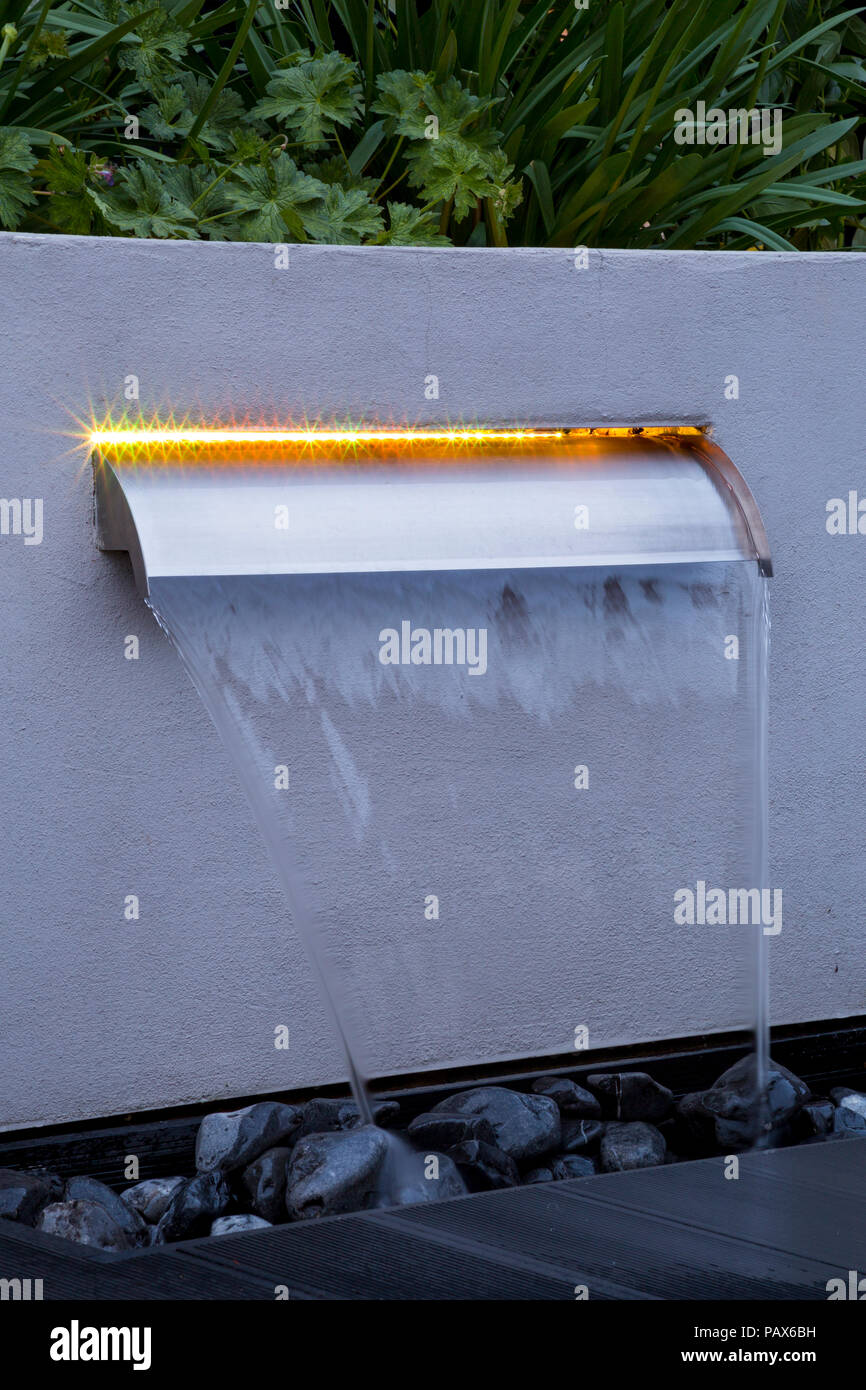 LED lighting element on a waterblade with a pebble pool Stock Photo - Alamy