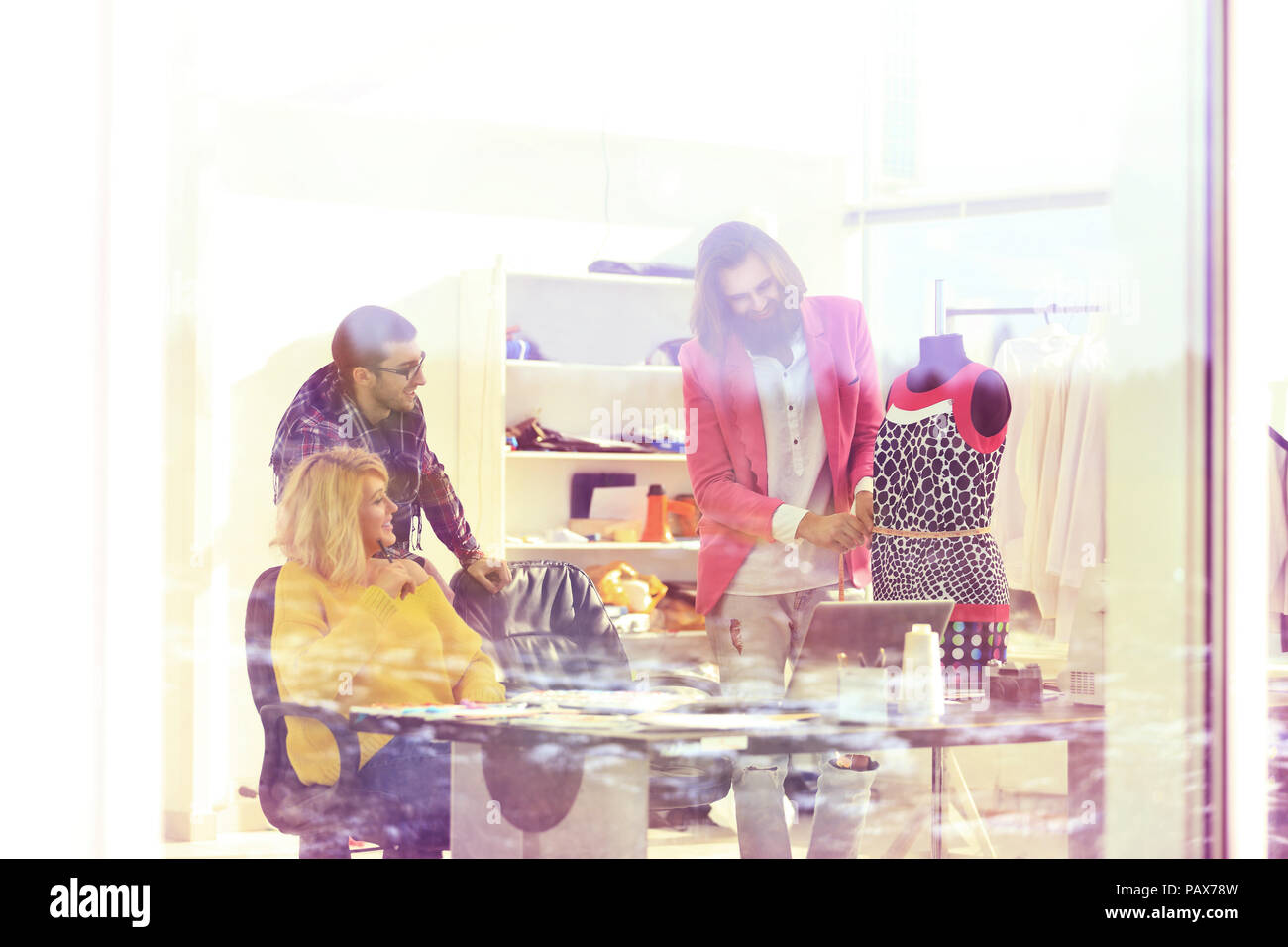 Group of fashion designers discussing designs in a studio Stock Photo ...