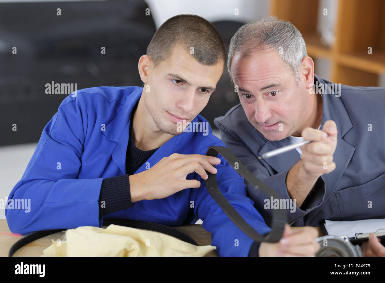 apprentice mechanic in auto shop working on car engine Stock Photo - Alamy