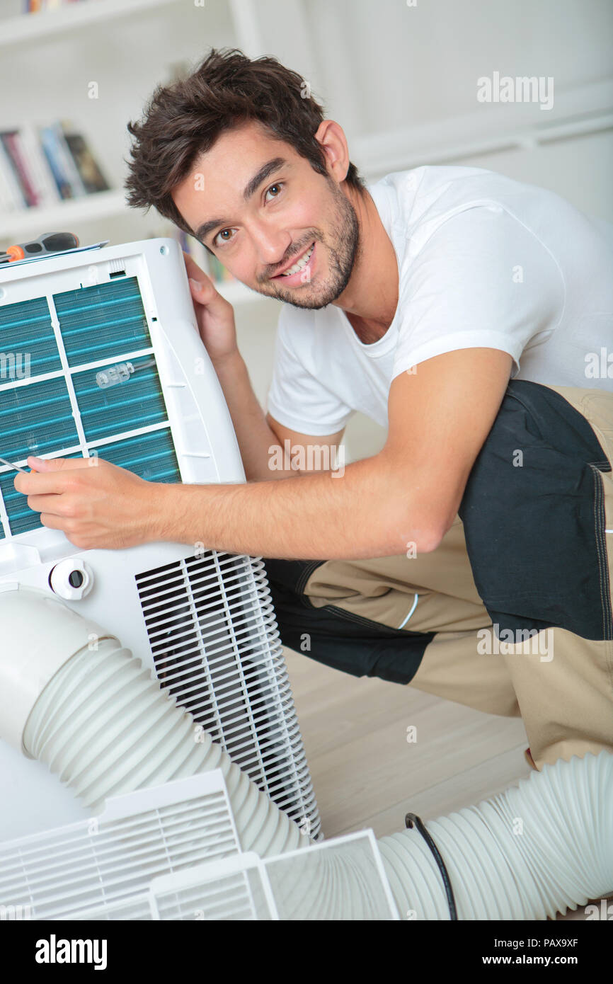 Portrait of man installing air conditioning Stock Photo - Alamy