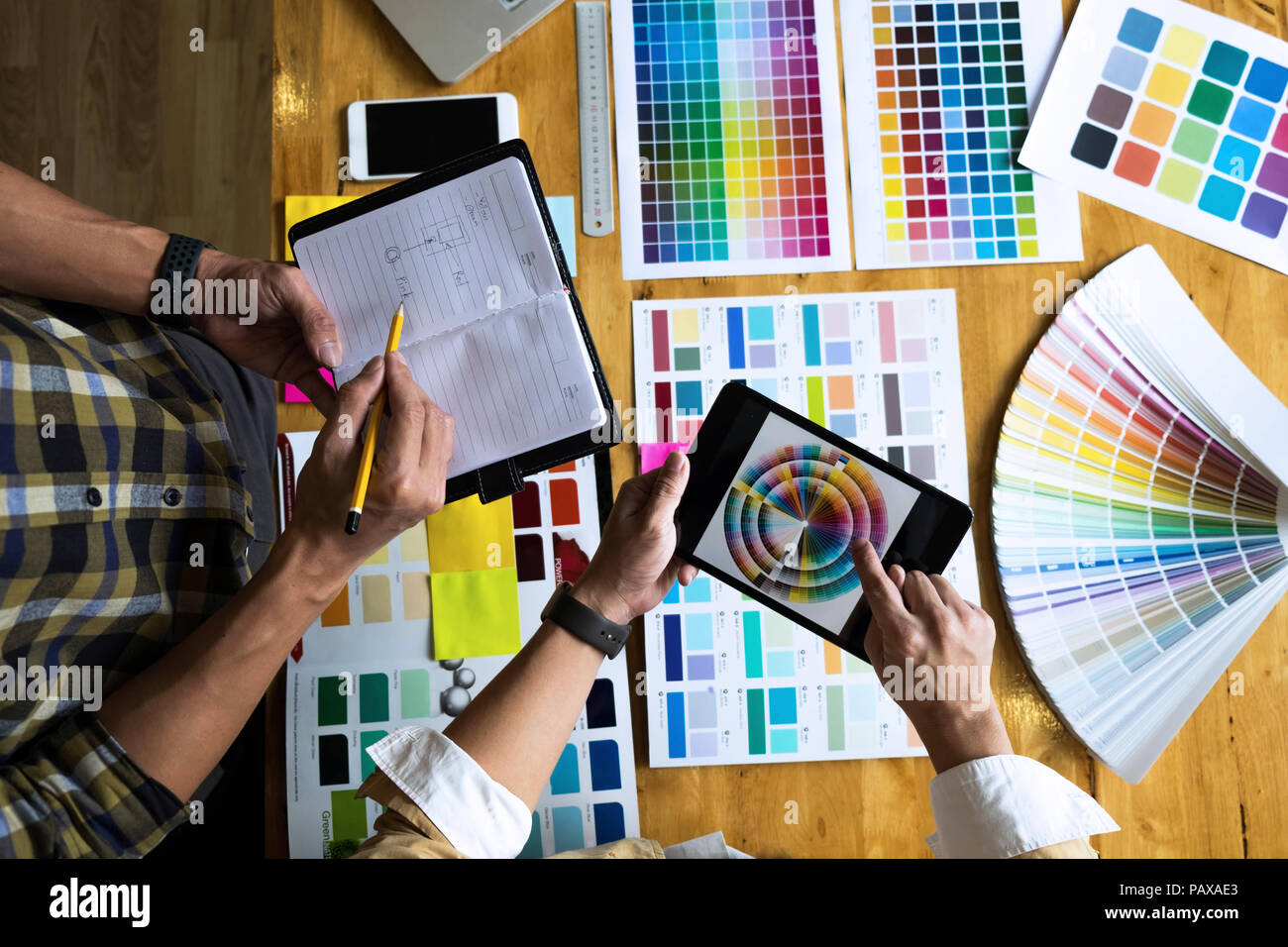 Graphic designers use the tablet to choose colors from the color bar ...
