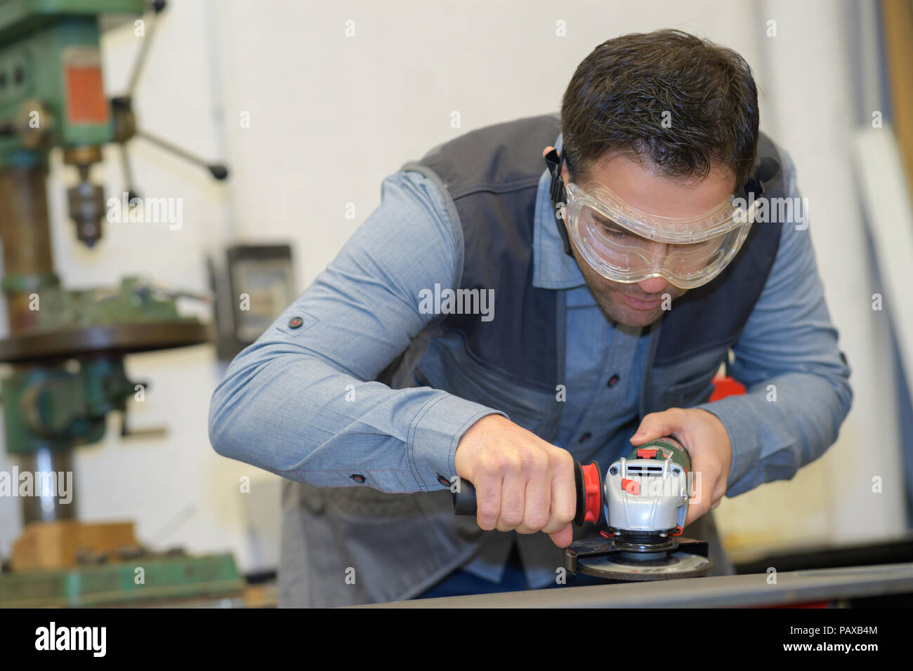 handyman using electric sander with safety glasses Stock Photo - Alamy