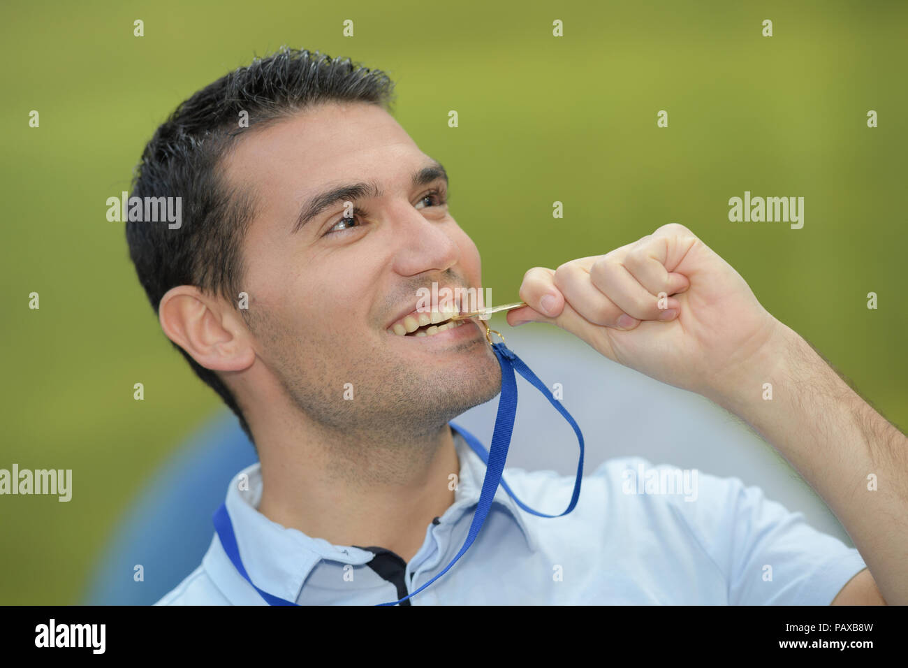 winner biting gold medal Stock Photo - Alamy