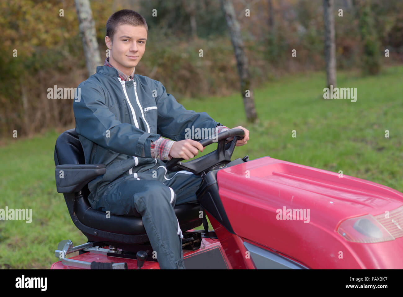 Man using ride on mower Stock Photo - Alamy