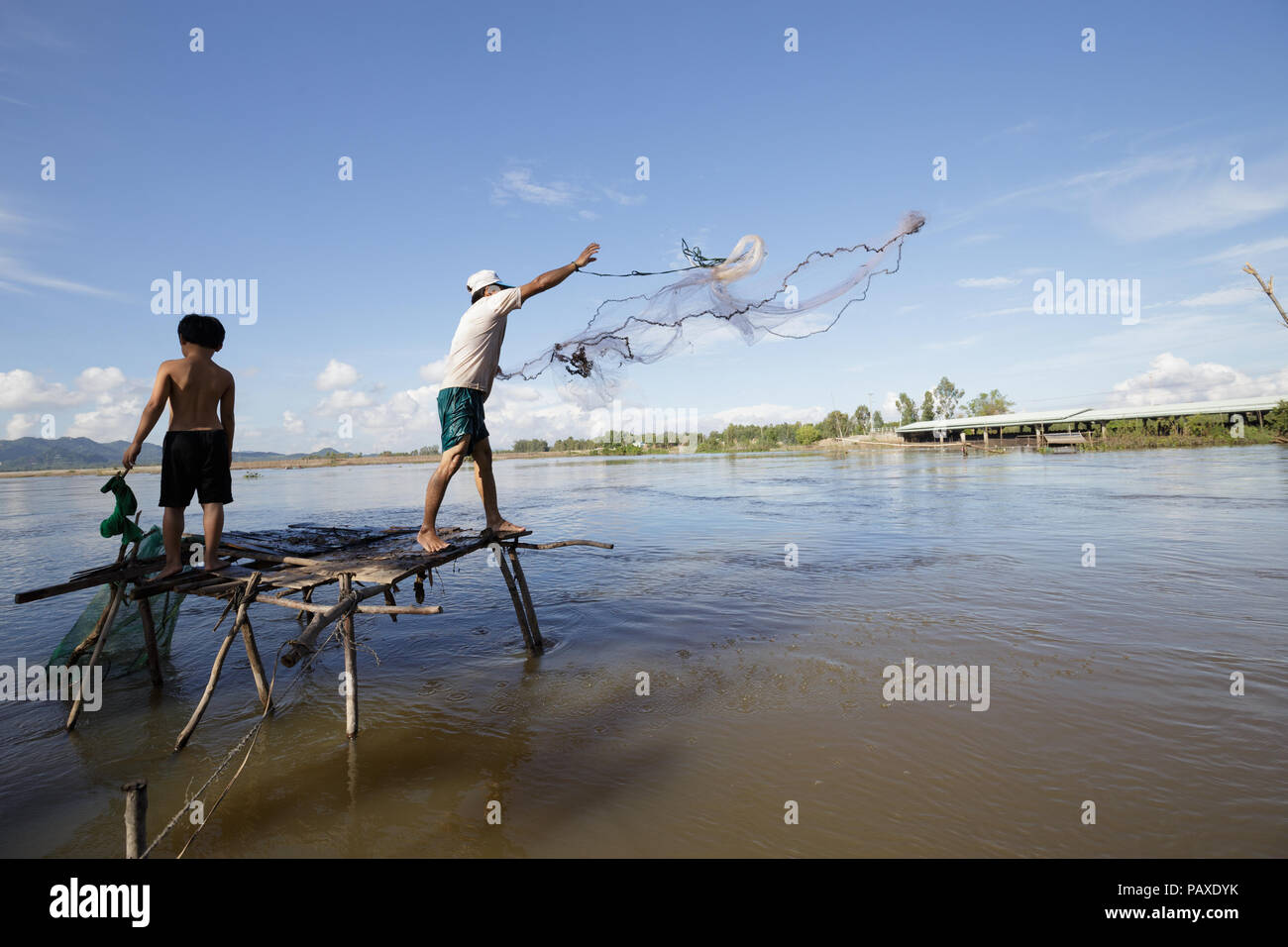 Man throwing fishing net in Vietnam Stock Photo - Alamy