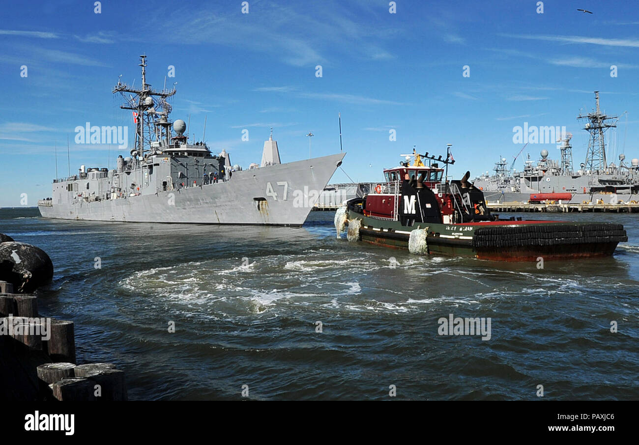 A tug tows the USS Nicholas. The Oliver Hazard Perry-class guided ...