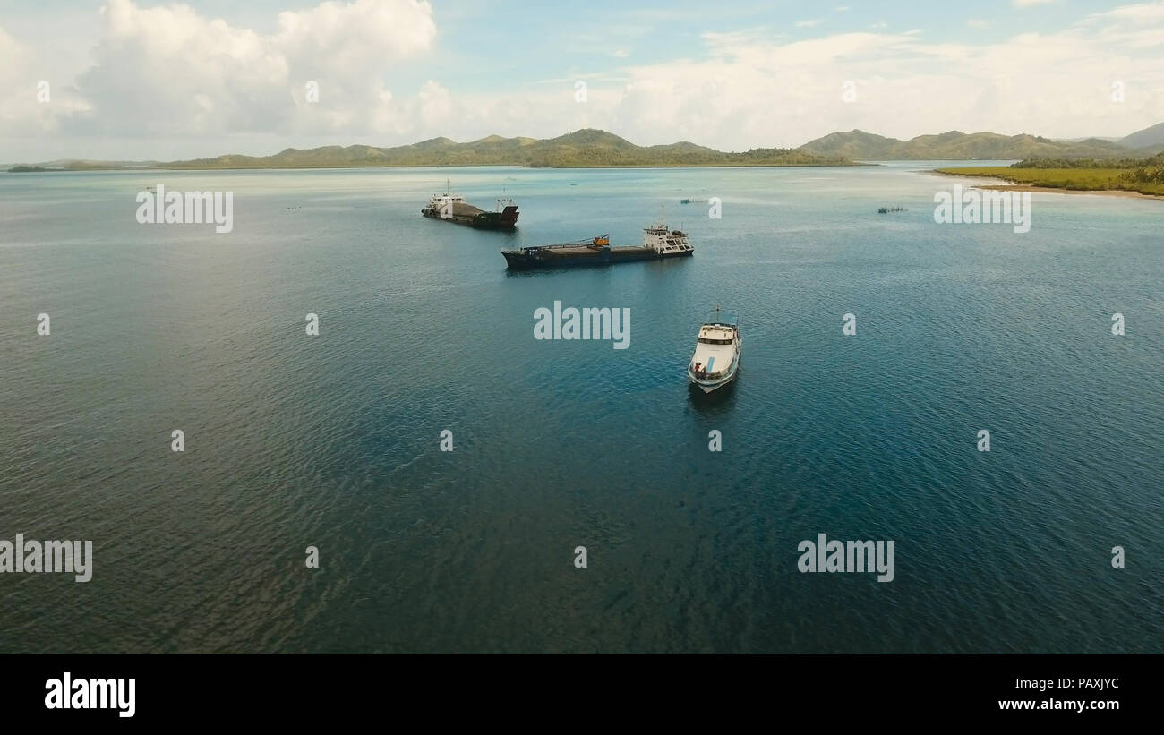 Aerial view Cargo and passenger ships in a beautiful lagoon on Siargao ...