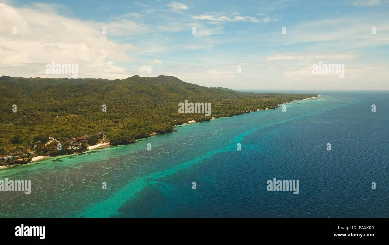 Aerial view: sea and the tropical island with beach,resort, hotels ...