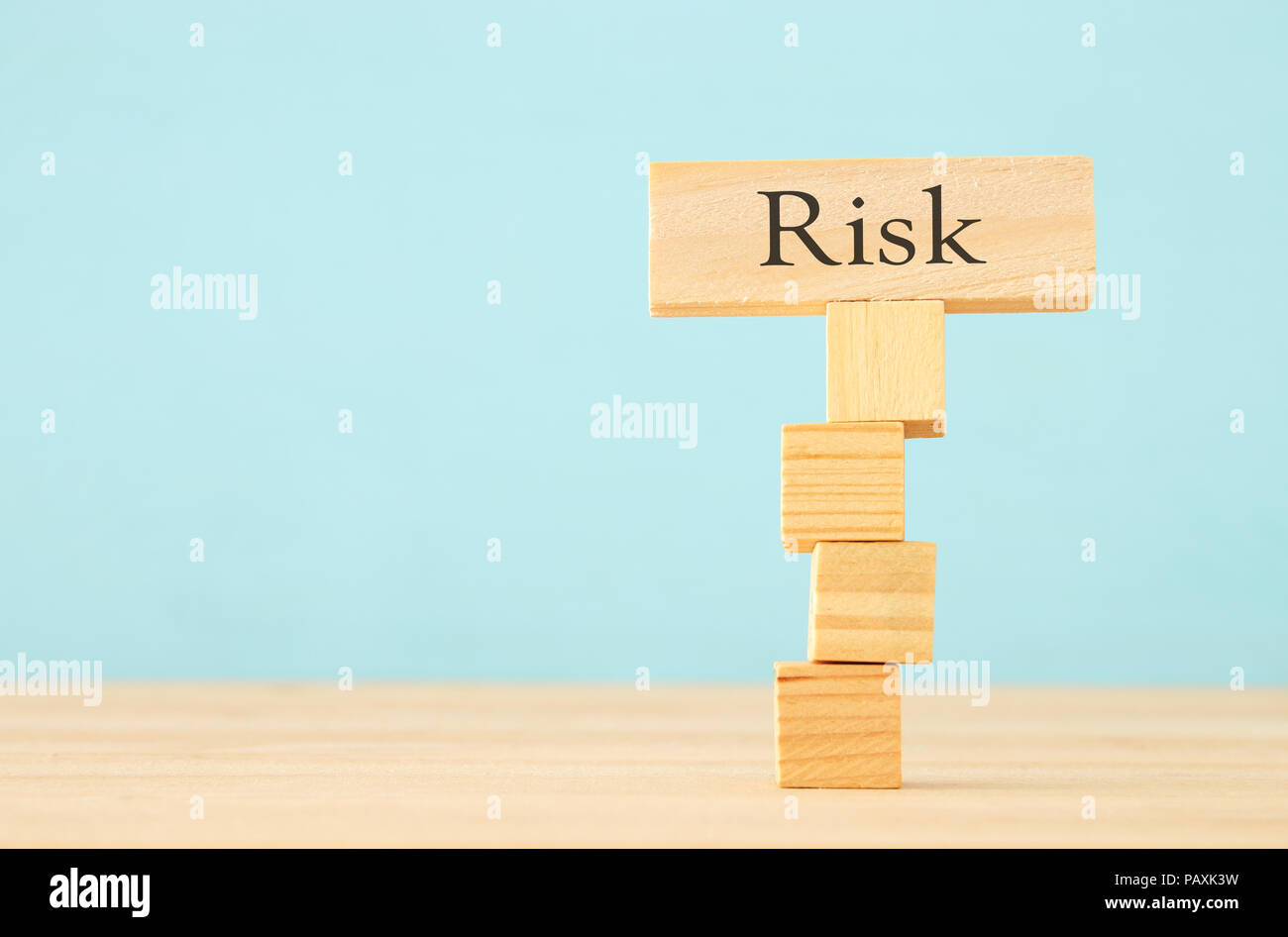 concept image of Wooden cubes that create an unstable structure and the ...