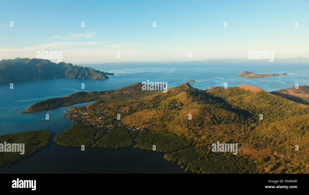 Aerial view: beach, tropical island, sea bay and lagoon, mountains with ...