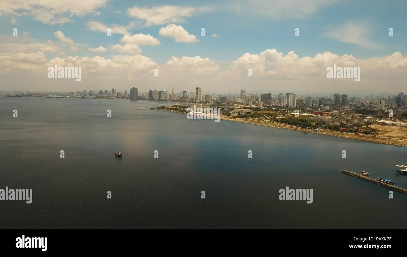 Aerial view of Manila city. Fly over city with skyscrapers and ...
