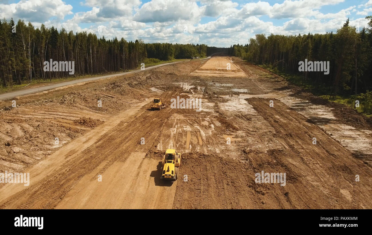 Construction of a new road in the forest area. Aerial view construction ...