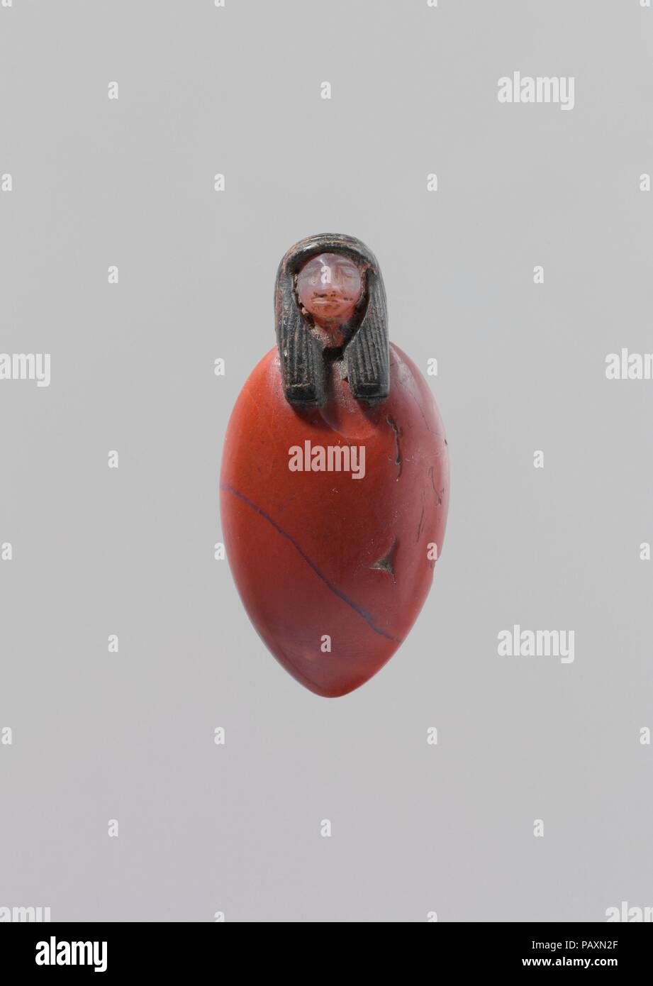 Heart amulet with human head. Dimensions: H. 5.4 cm (2 1/8 in); w. 2.7 ...