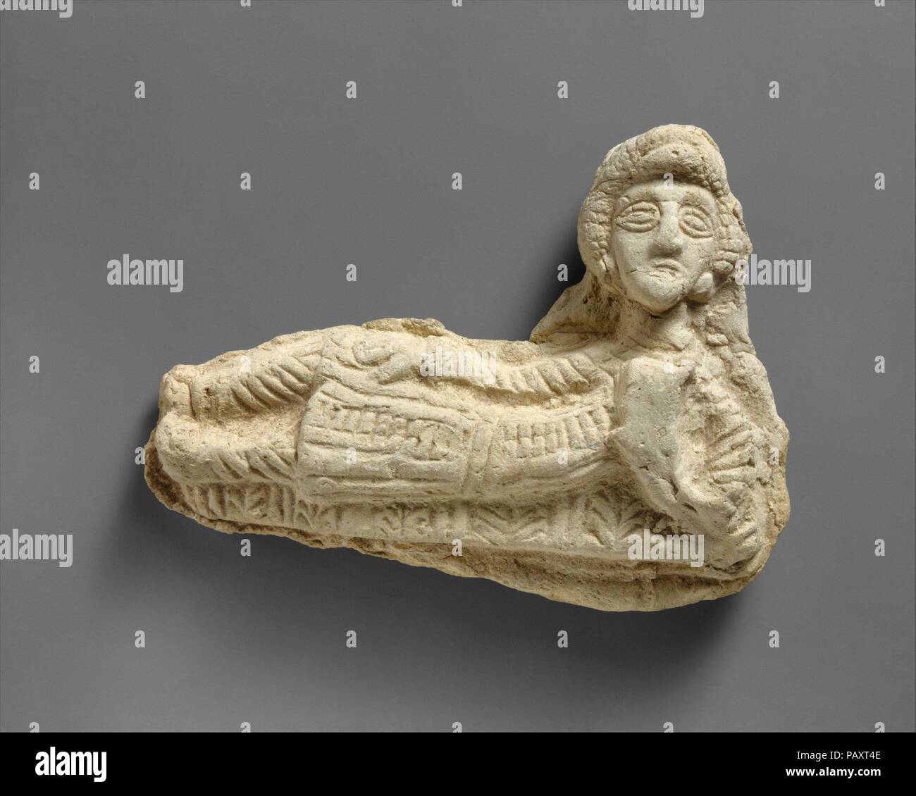 Plaque in the form of a reclining man. Culture: Parthian. Dimensions: 4 ...
