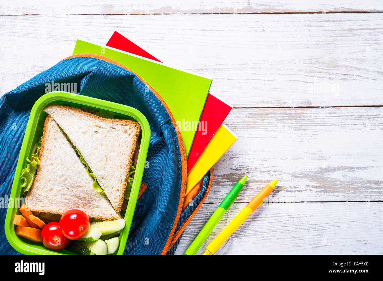 Back to school concept. Lunch box, stationery and backpack Stock Photo ...