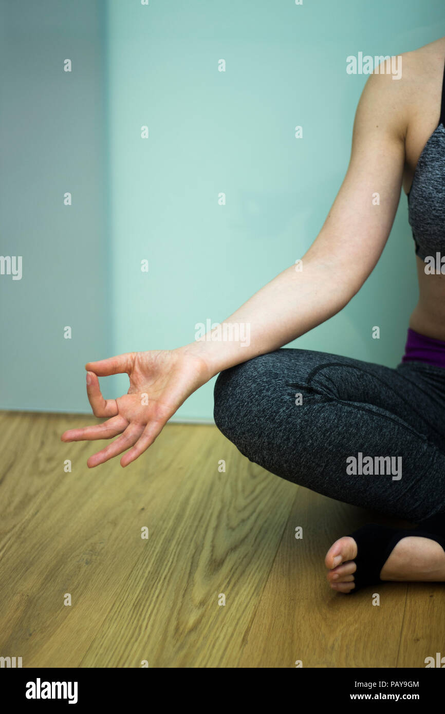 Female instructor yoga teacher teaching asana pose with mudra hand ...